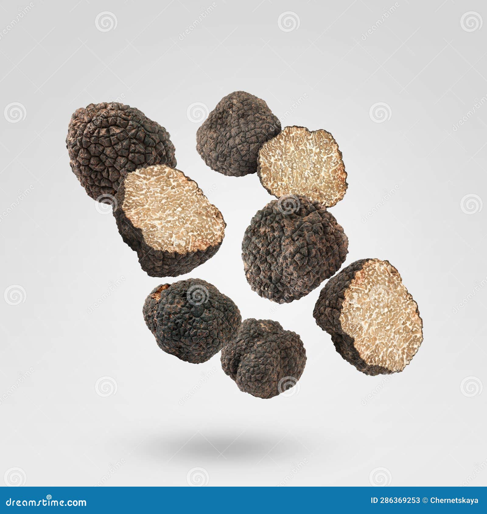 Cut and Whole Truffles Falling on Light Grey Background Stock Image ...