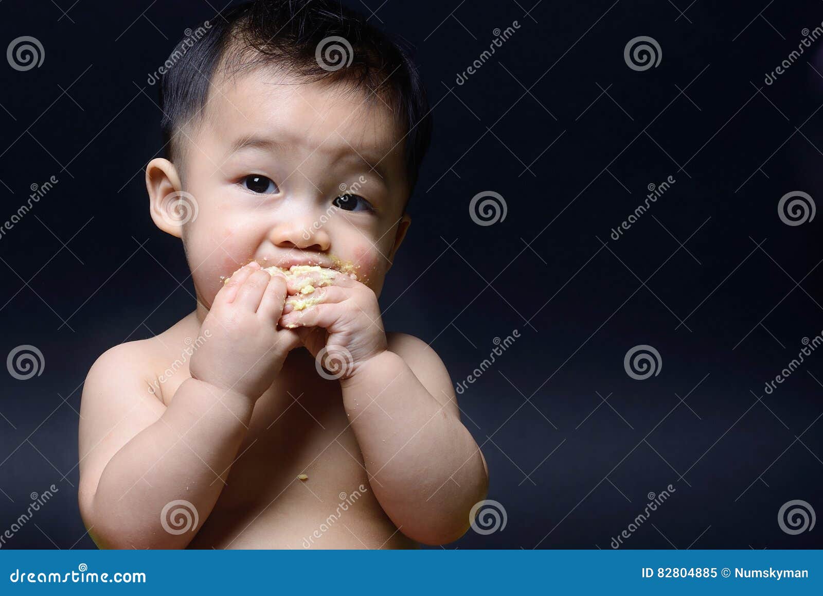 Cute Asian Baby Boy is Eating Cake with Both His Hand Stock Image ...