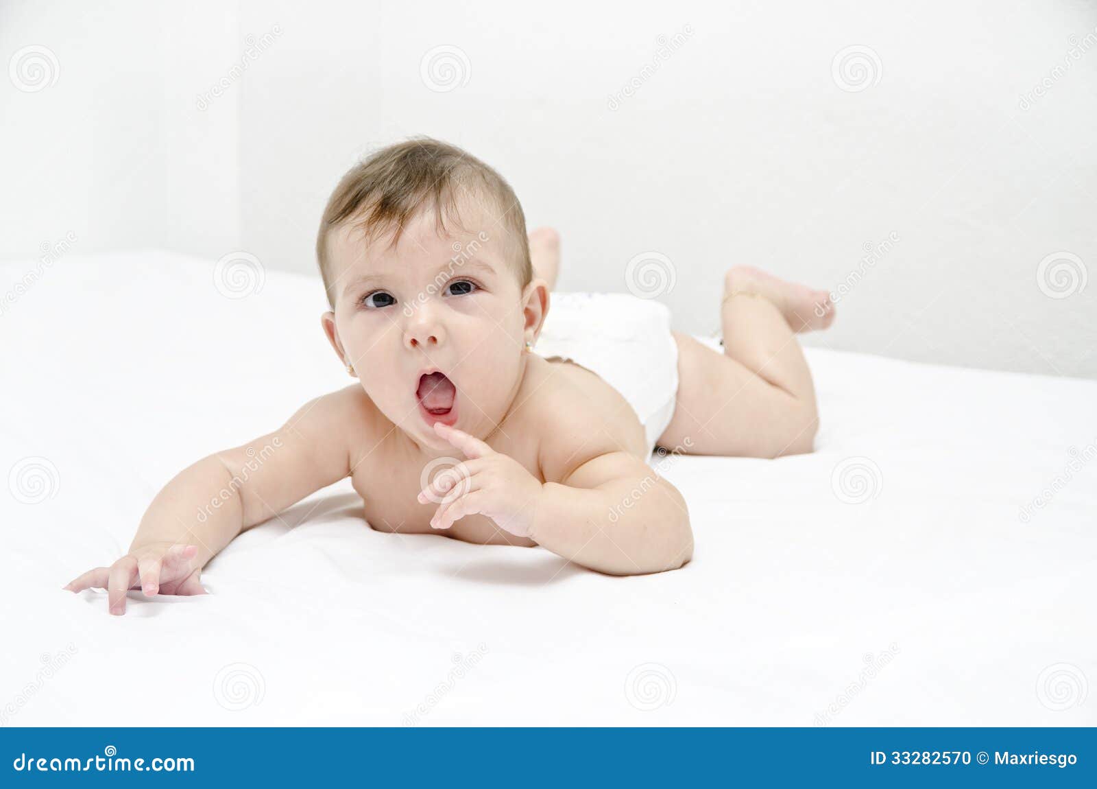 Cute baby biting finger stock photo. Image of looking - 33282570
