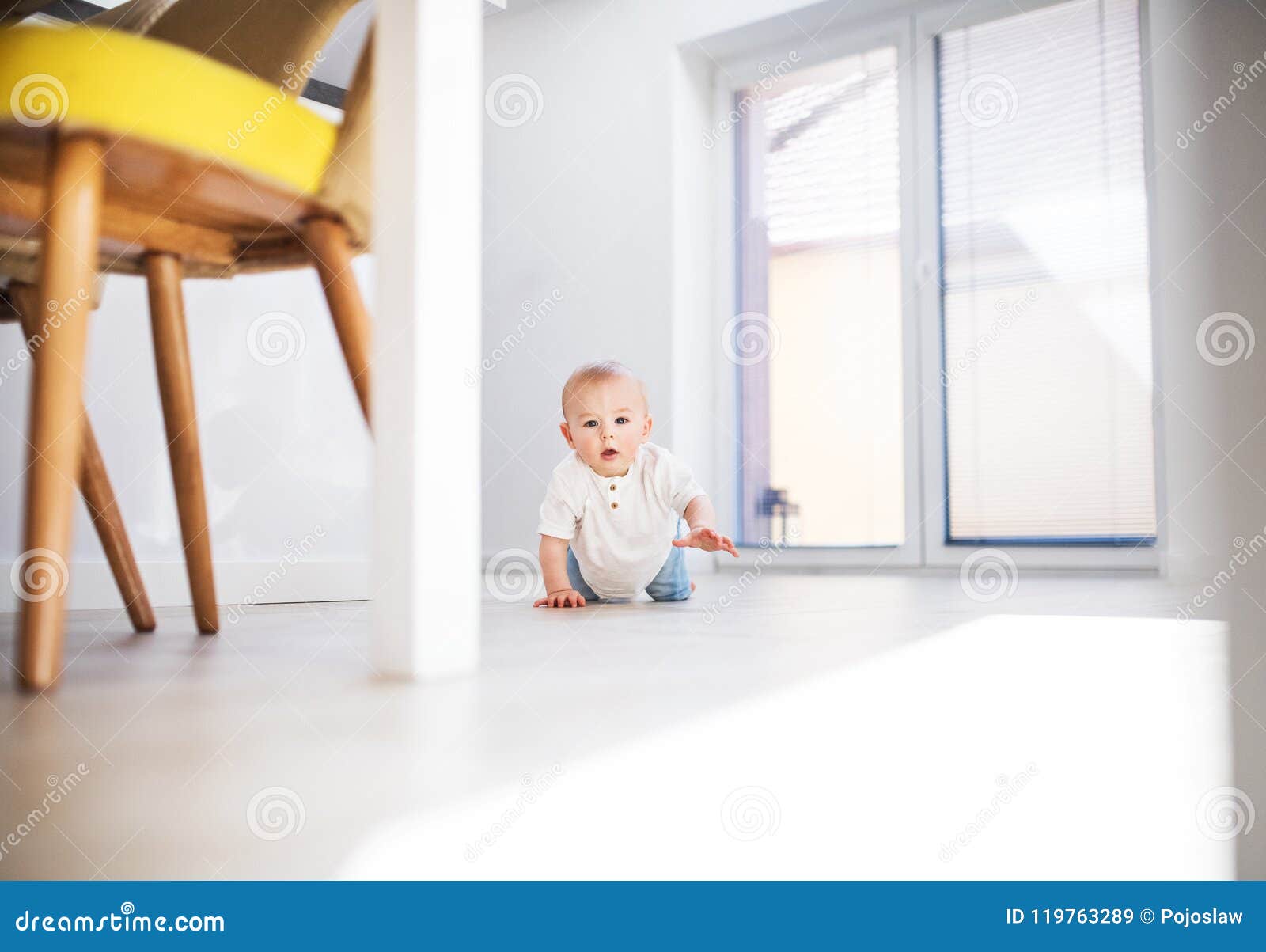 A Baby Boy Crawling on the Floor at Home. Stock Image - Image of ...