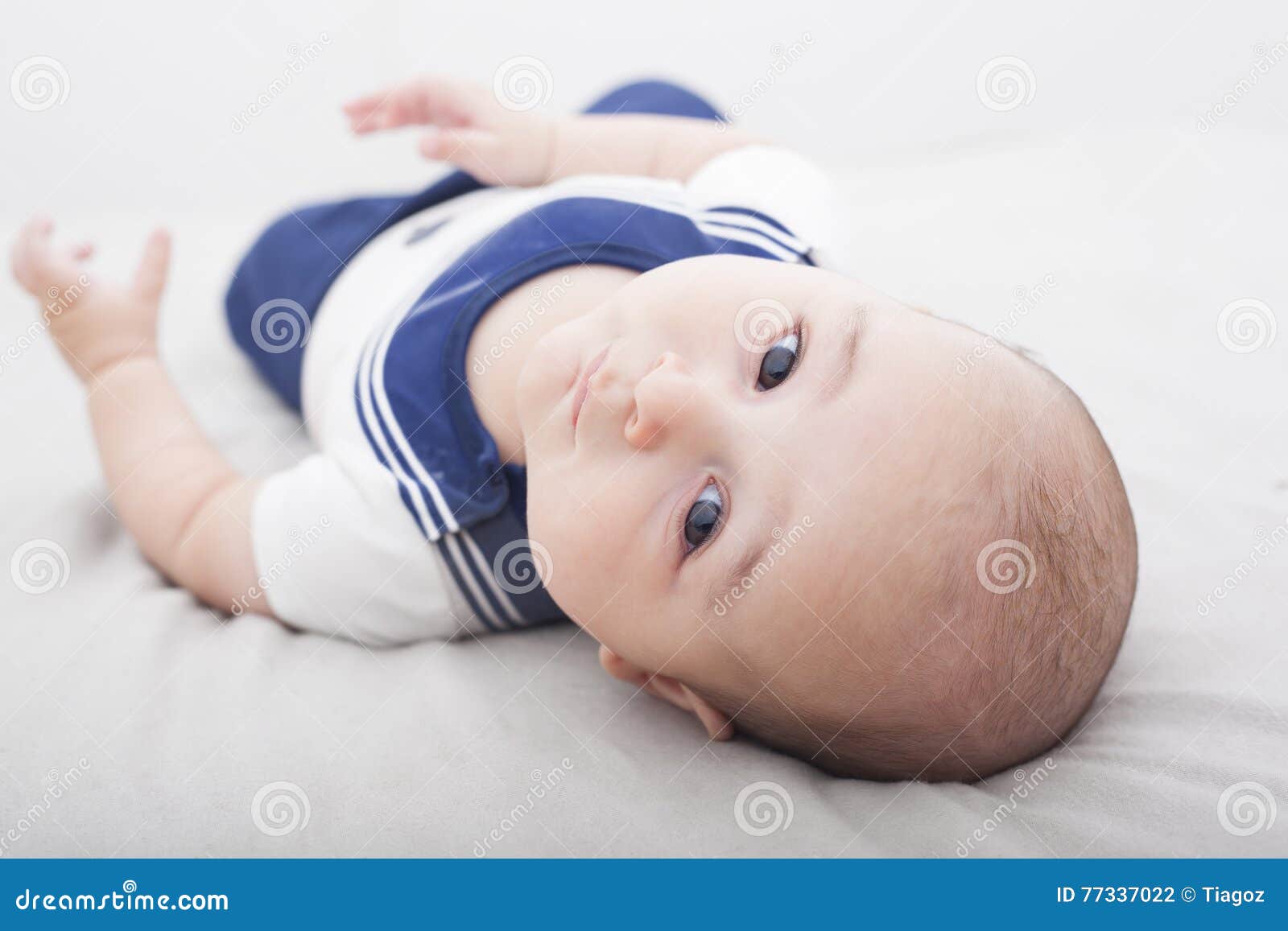 Cute baby boy on his back stock photo. Image of mixed - 77337022