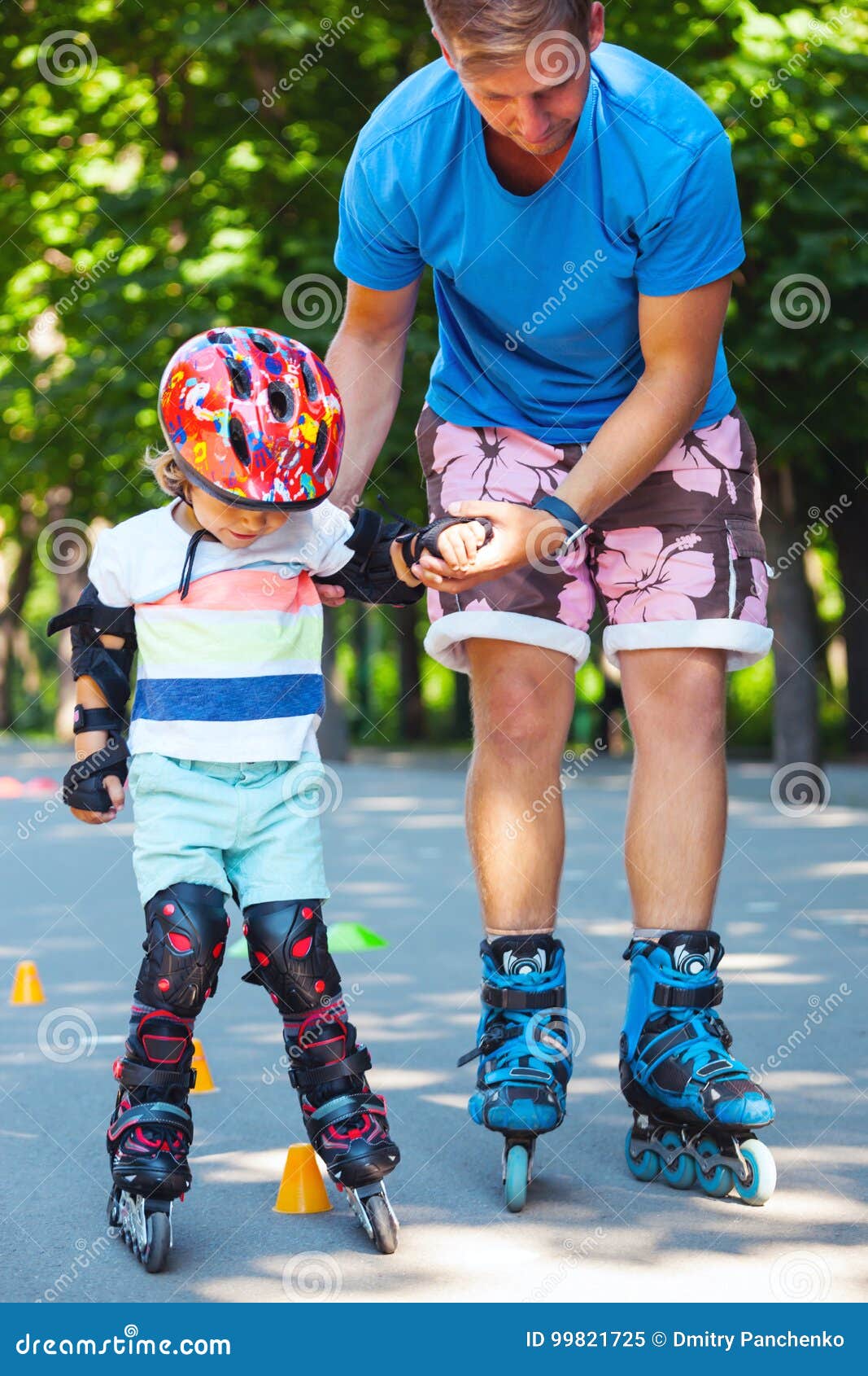 Cute Baby Boy with Inline Skating Instructor in the Park Learining To ...