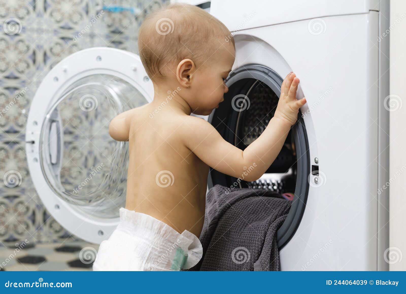 Cute Baby Boy is Looking Inside the Washing Machine Stock Image - Image ...