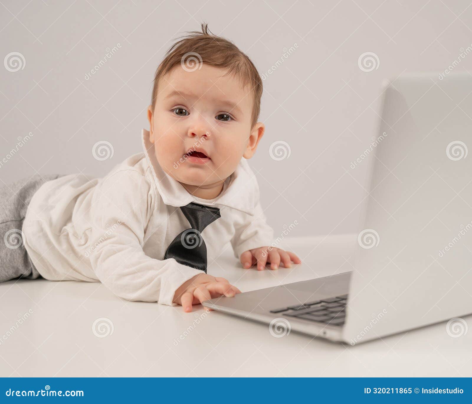 Cute Baby Boy in a Tie Working at a Laptop. Stock Image - Image of ...