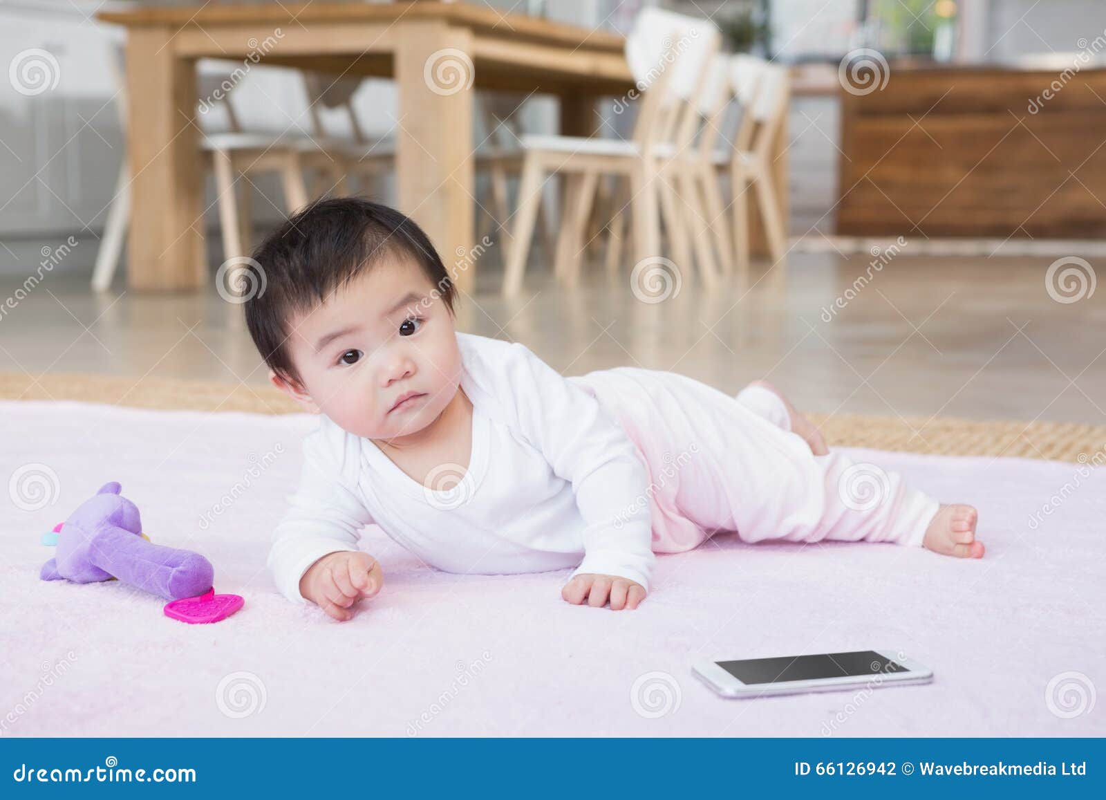 Cute baby on the carpet stock photo. Image of smartphone - 66126942