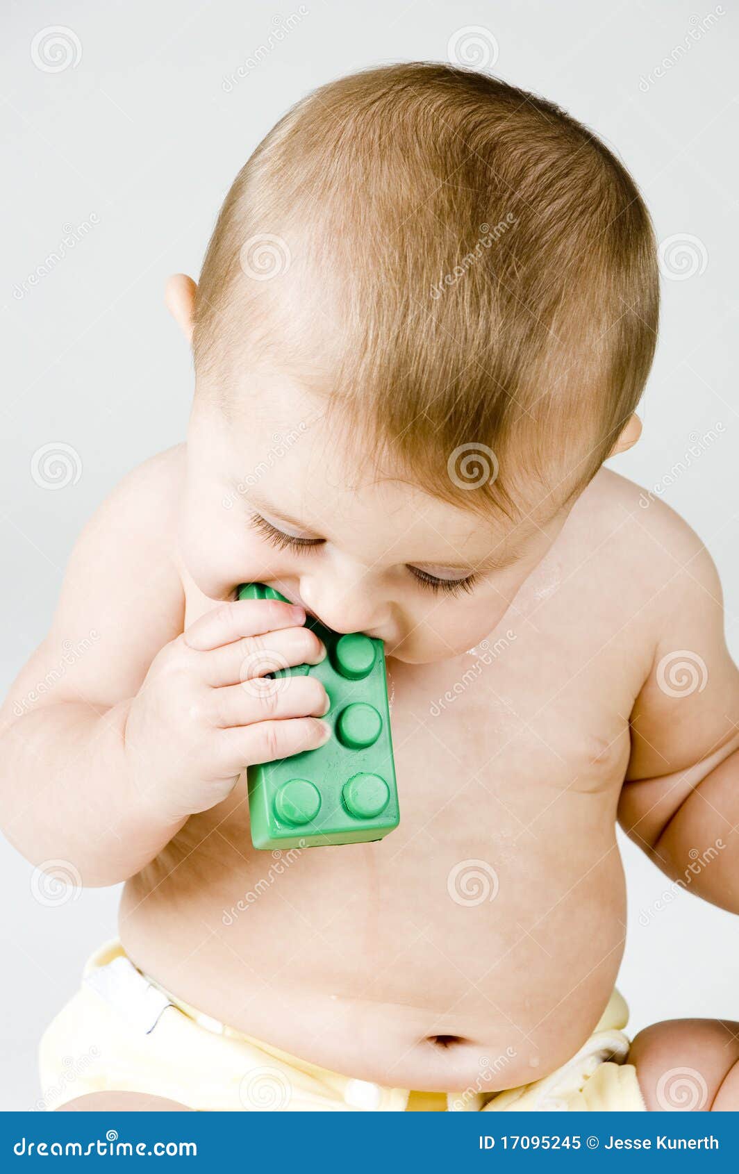 Cute Baby Chewing on Toy stock image. Image of months - 17095245
