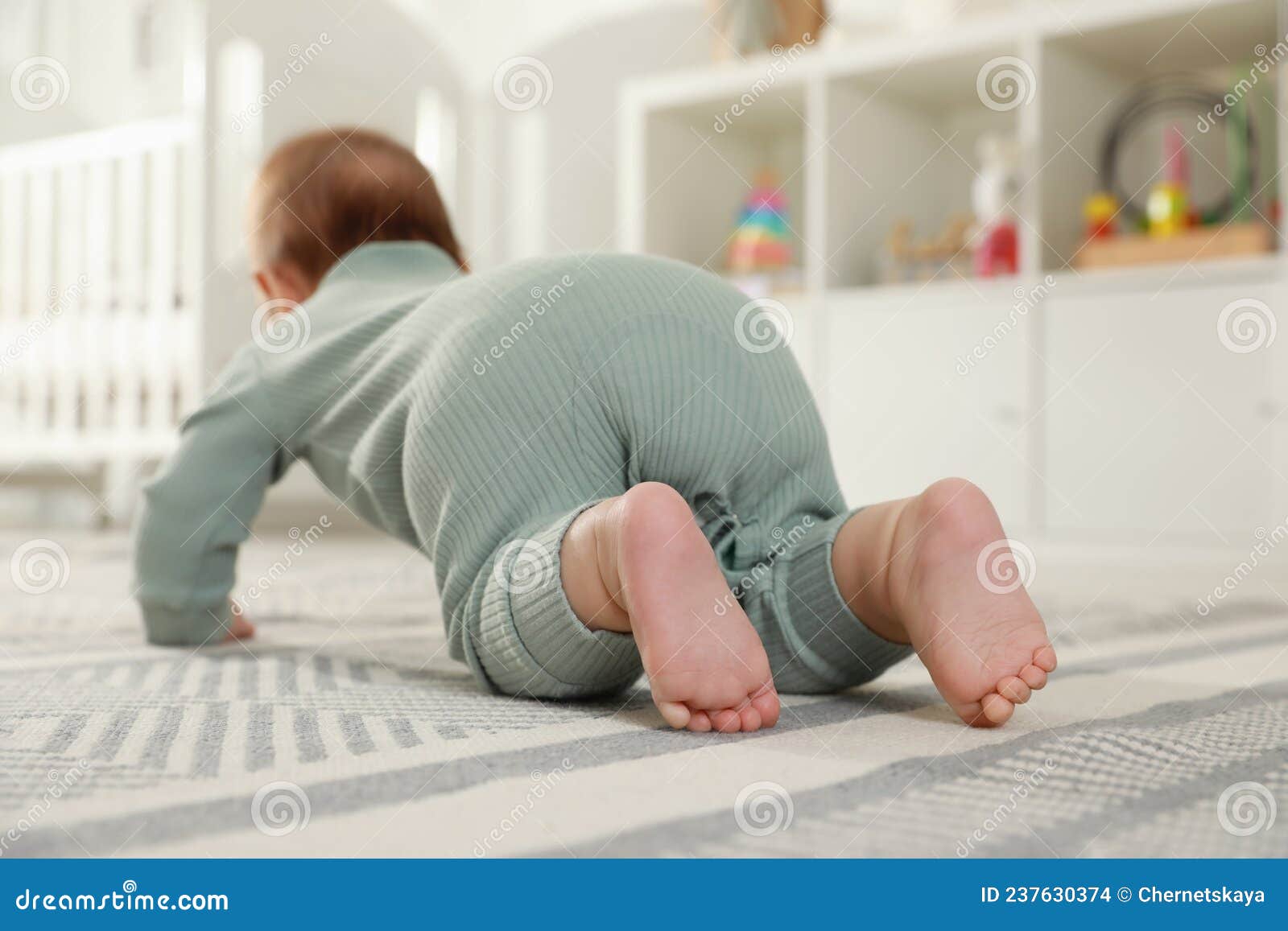 Cute Baby Crawling on Floor at Home, Back View Stock Photo - Image of ...