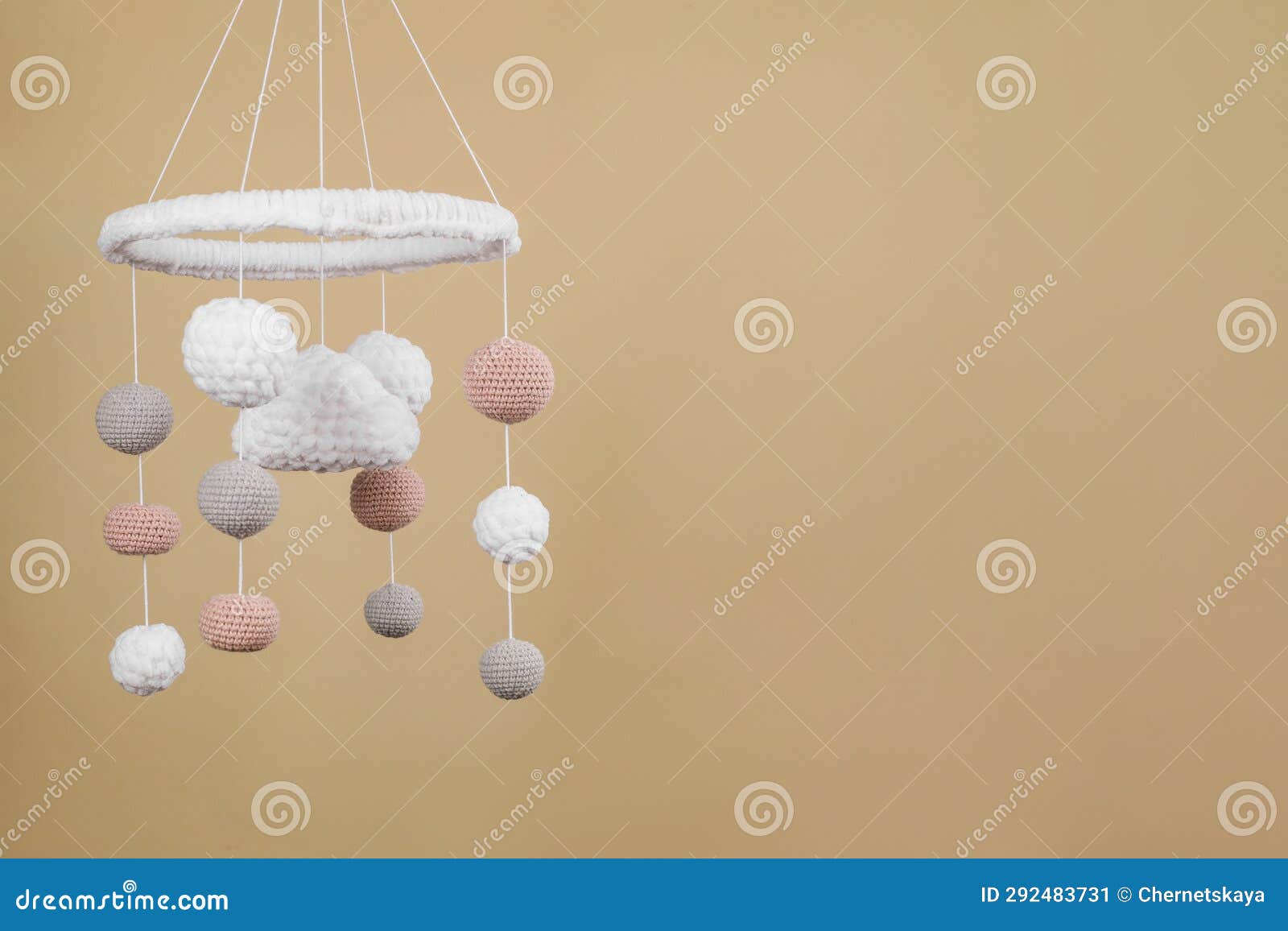 Cute Baby Crib Mobile on Beige Background. Space for Text Stock Image ...