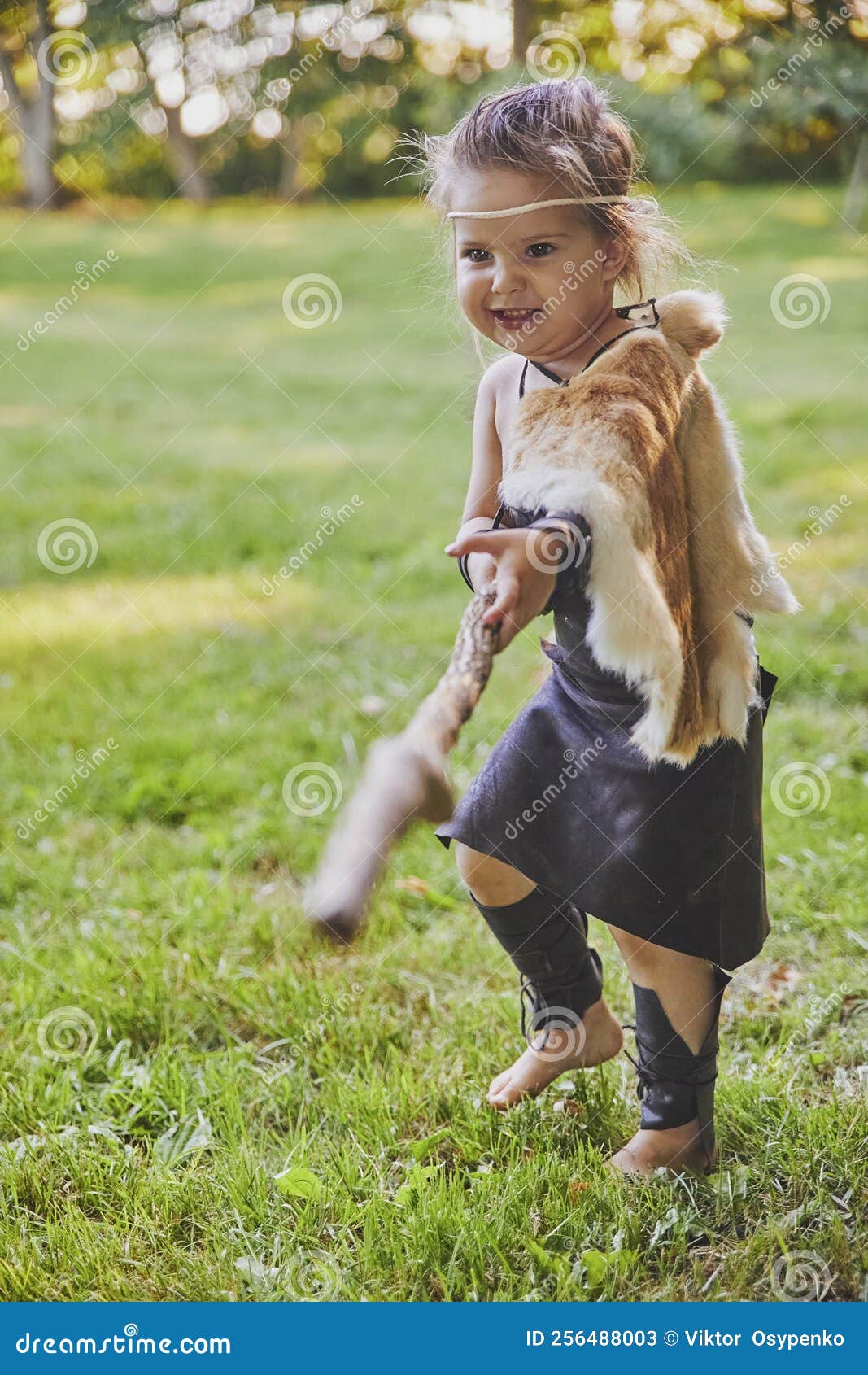 Cute Baby Dressed in the Clothes of Primitive People with Combat Staff ...