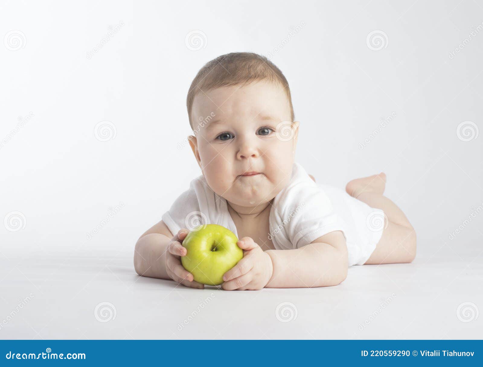 Cute Baby Eating Green Apple, on White Background Stock Photo - Image ...