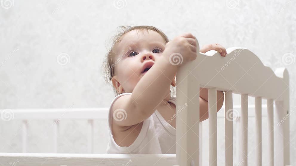 Cute Baby Plays in a Baby Cot Stock Photo - Image of active, game ...