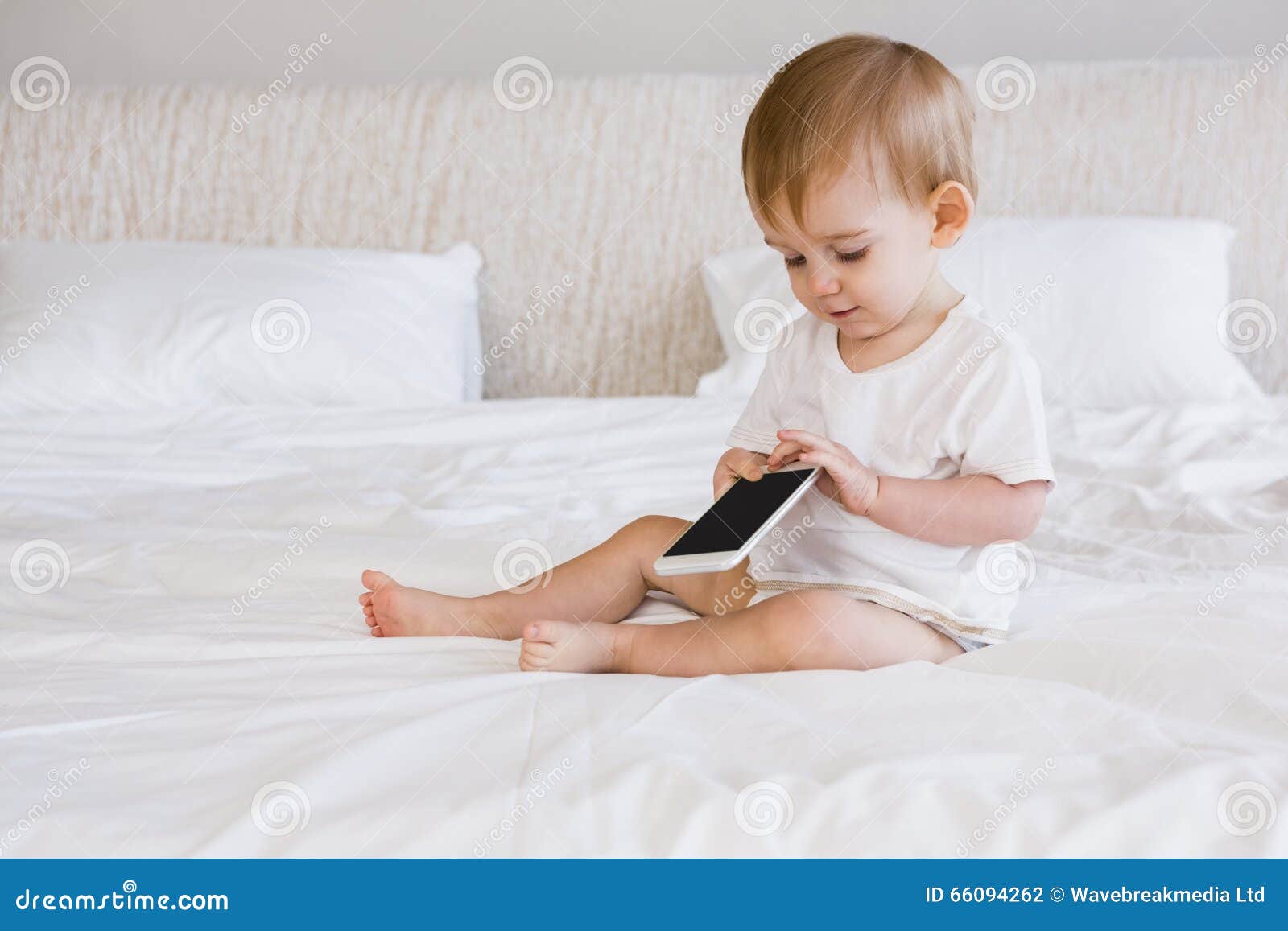 Cute baby using smartphone stock photo. Image of apartment - 66094262