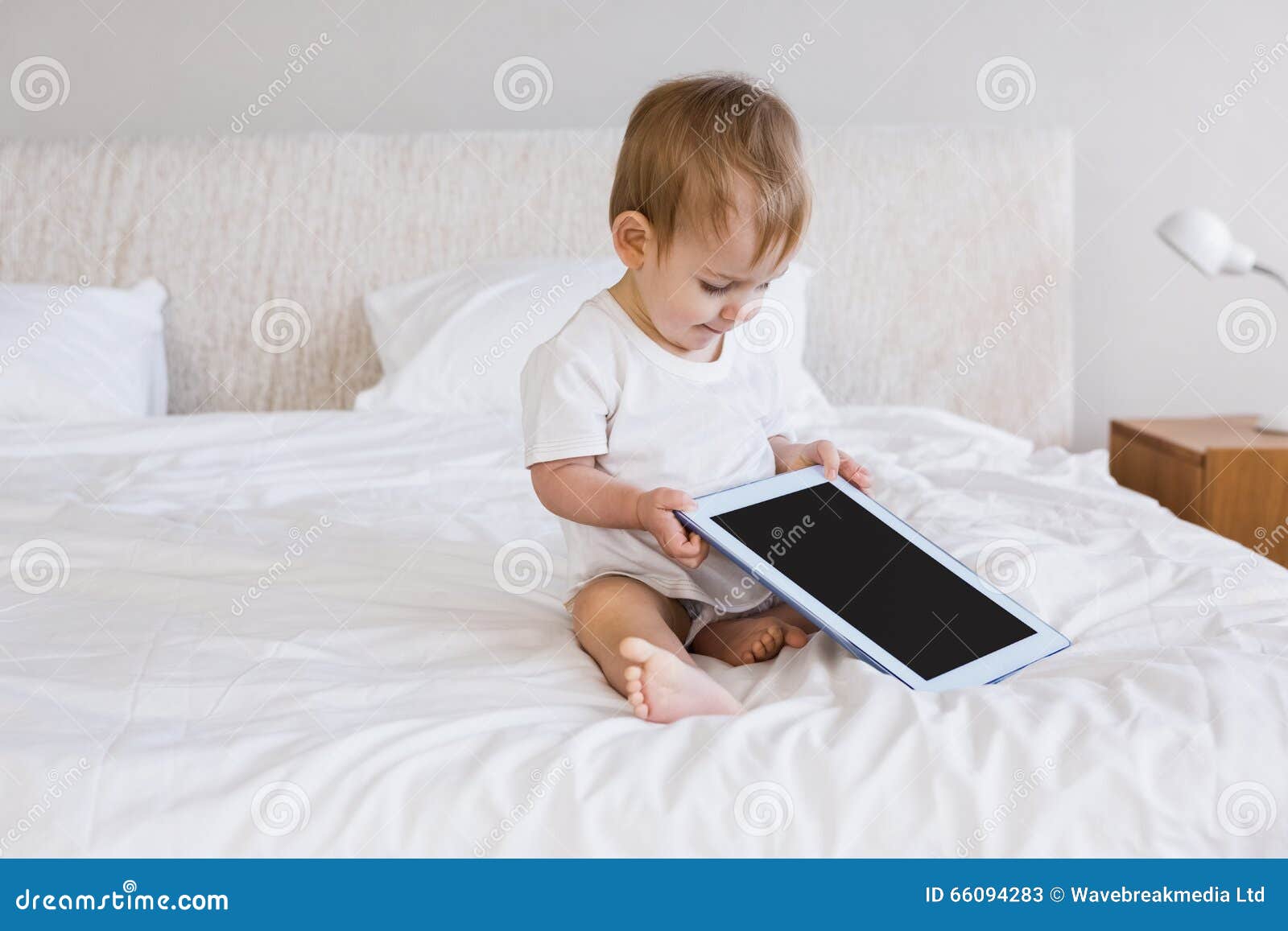 Cute baby using tablet stock image. Image of apartment - 66094283