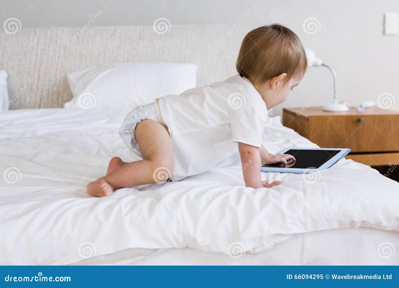 Cute baby using tablet stock image. Image of bedroom - 66094295