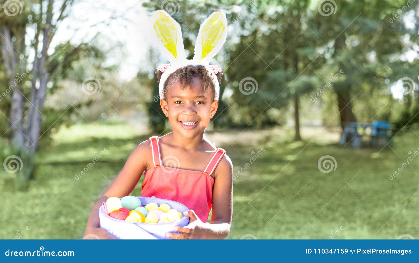 Cute African American Girl Wearing Bunny Ears Holding Easter Ba Stock