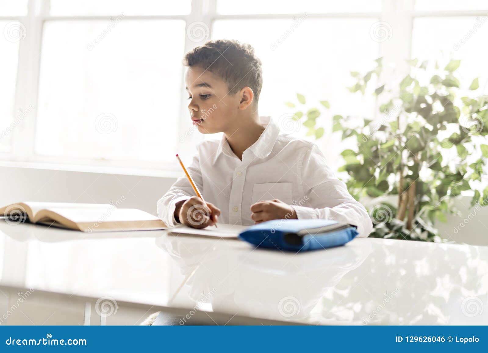 A Cute Black Boy Doing Homework at Home Stock Photo - Image of note ...