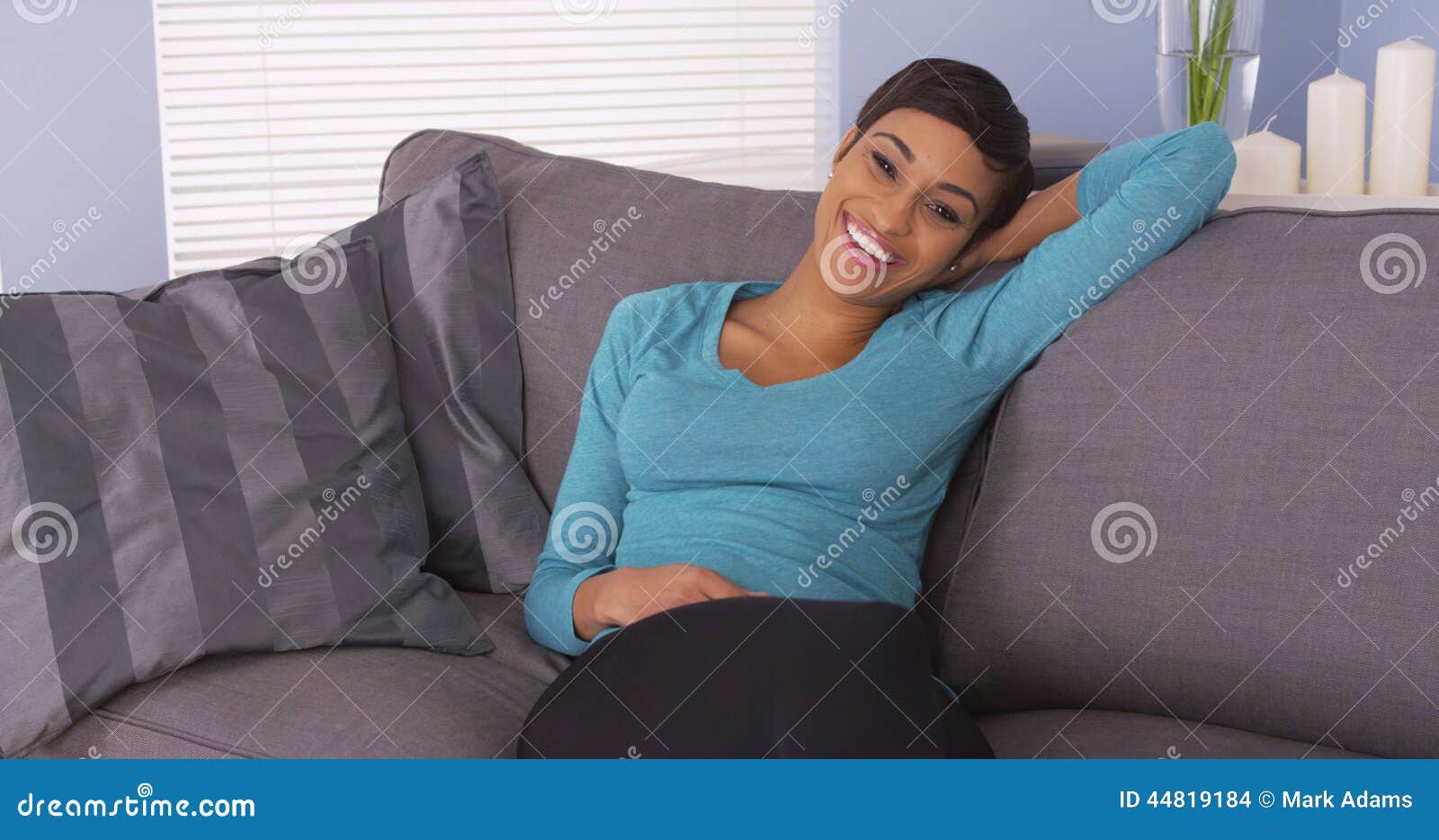 Cute Black Woman Resting on Couch Smiling Stock Photo - Image of ...