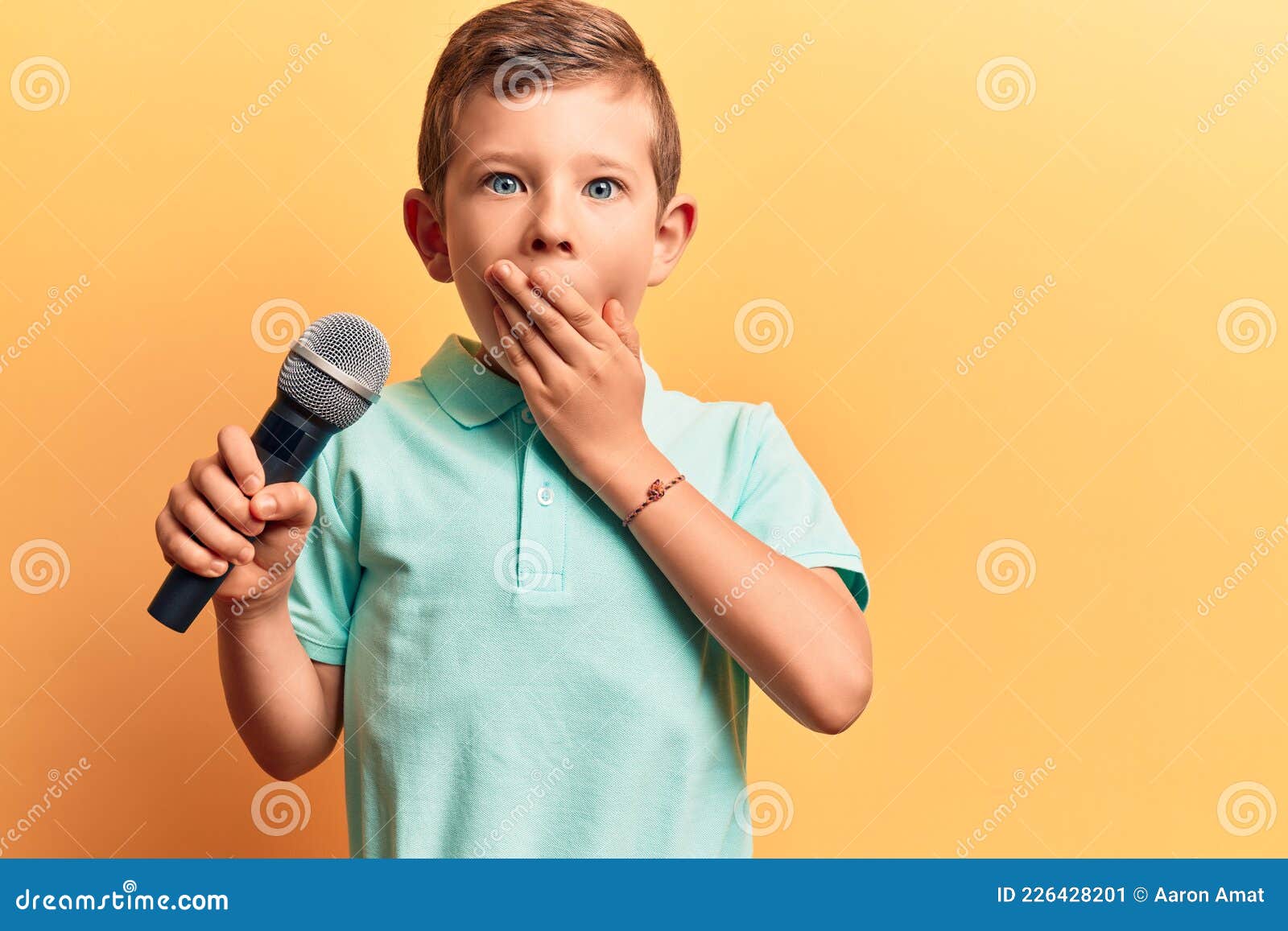Cute Blond Kid Singing Song Using Microphone Covering Mouth with Hand ...