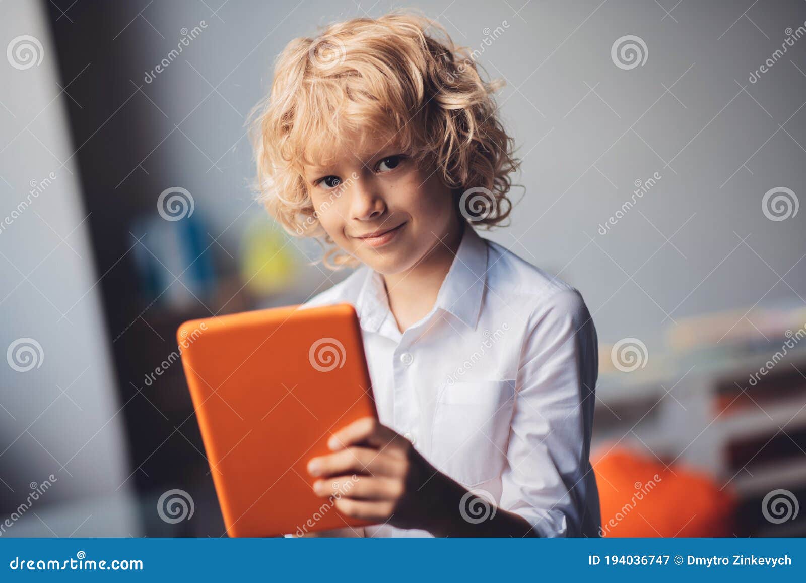 Cute Blonde Boy Holding His Tablet and Smiling Stock Image - Image of ...