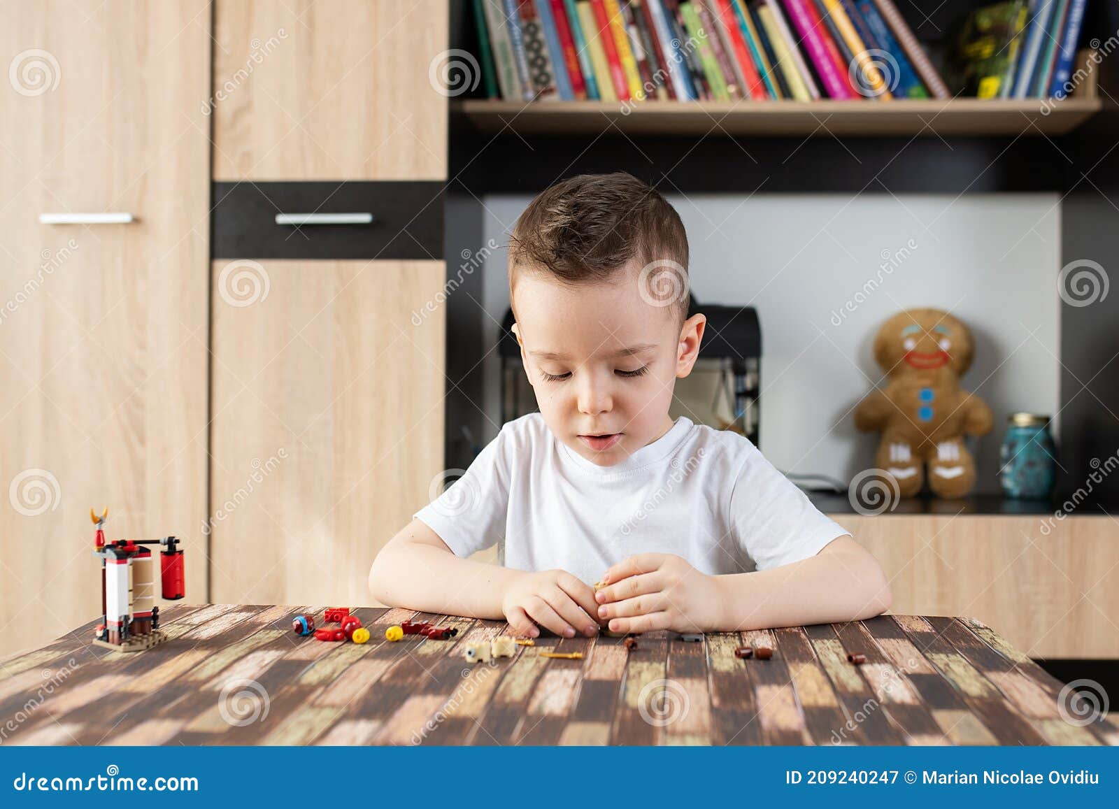 Cute Boy Assembling Plastic Toys at His Table Stock Image - Image of ...