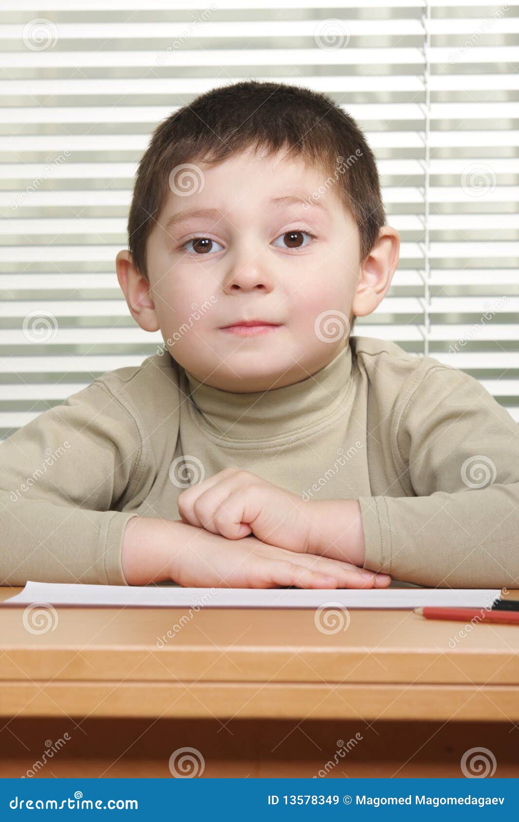 Cute boy at desk stock image. Image of folded, hands - 13578349
