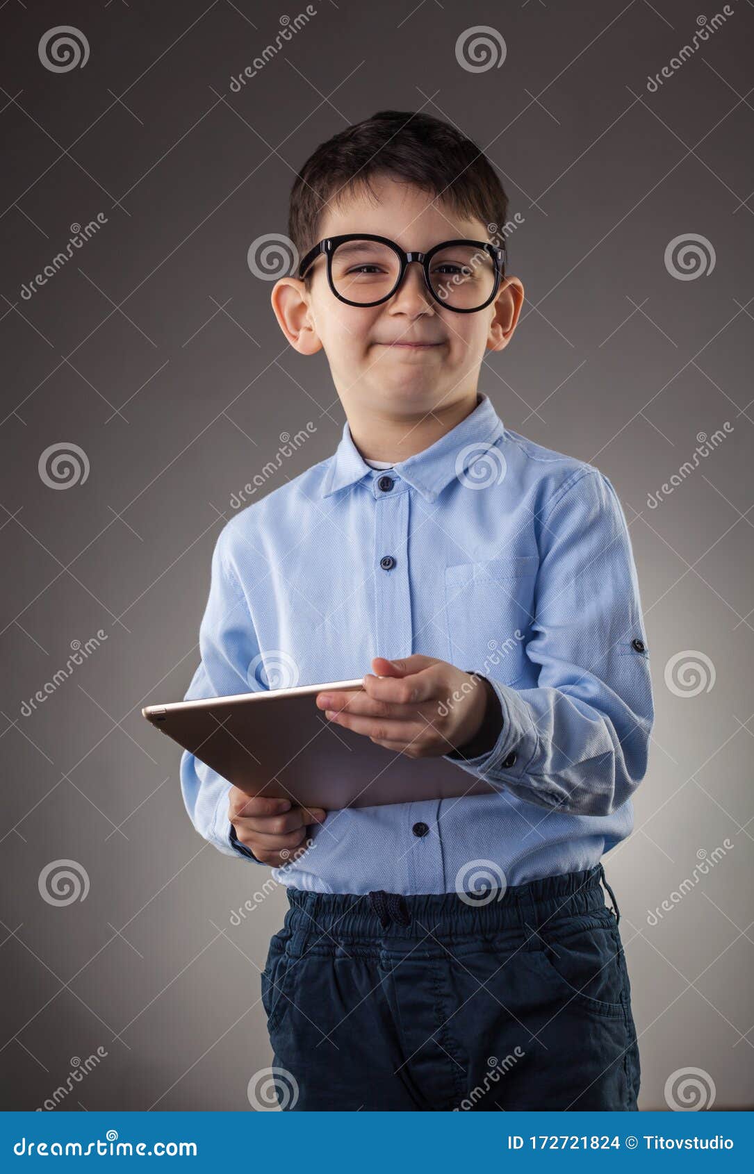 Cute Boy with Electronic Tablet on the Gray Background Stock Photo ...