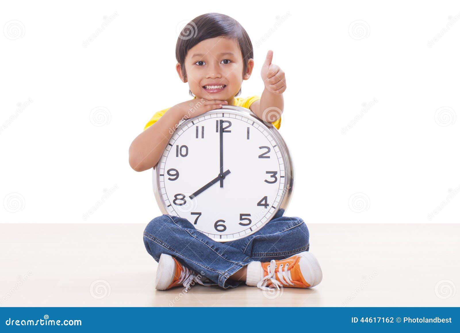 Cute boy holding clock stock photo. Image of confident - 44617162