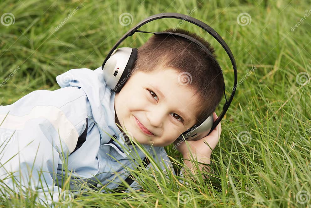 Cute boy laying in grass stock image. Image of people - 16400011