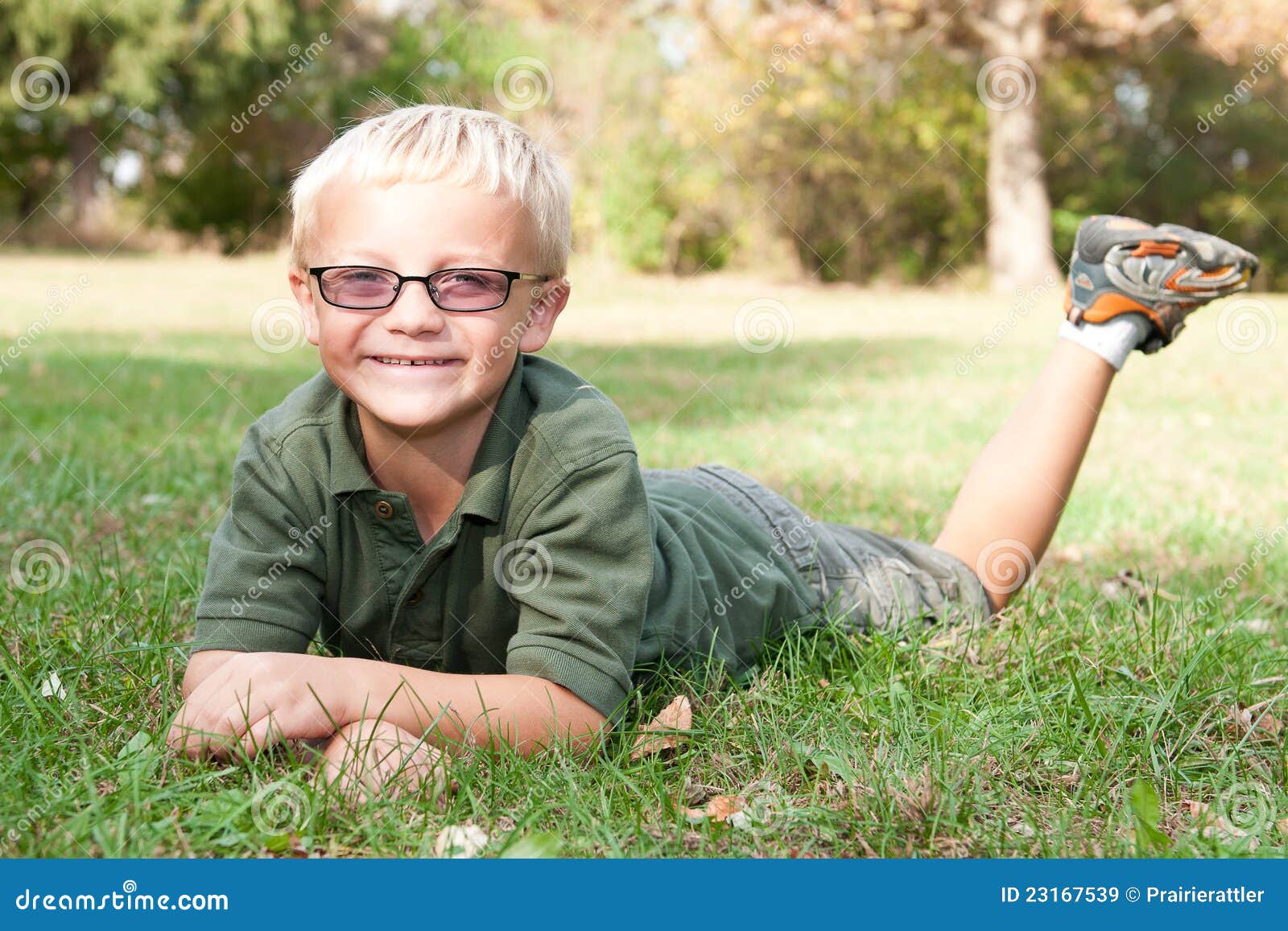 Cute Boy Laying in Grass stock image. Image of happy - 23167539