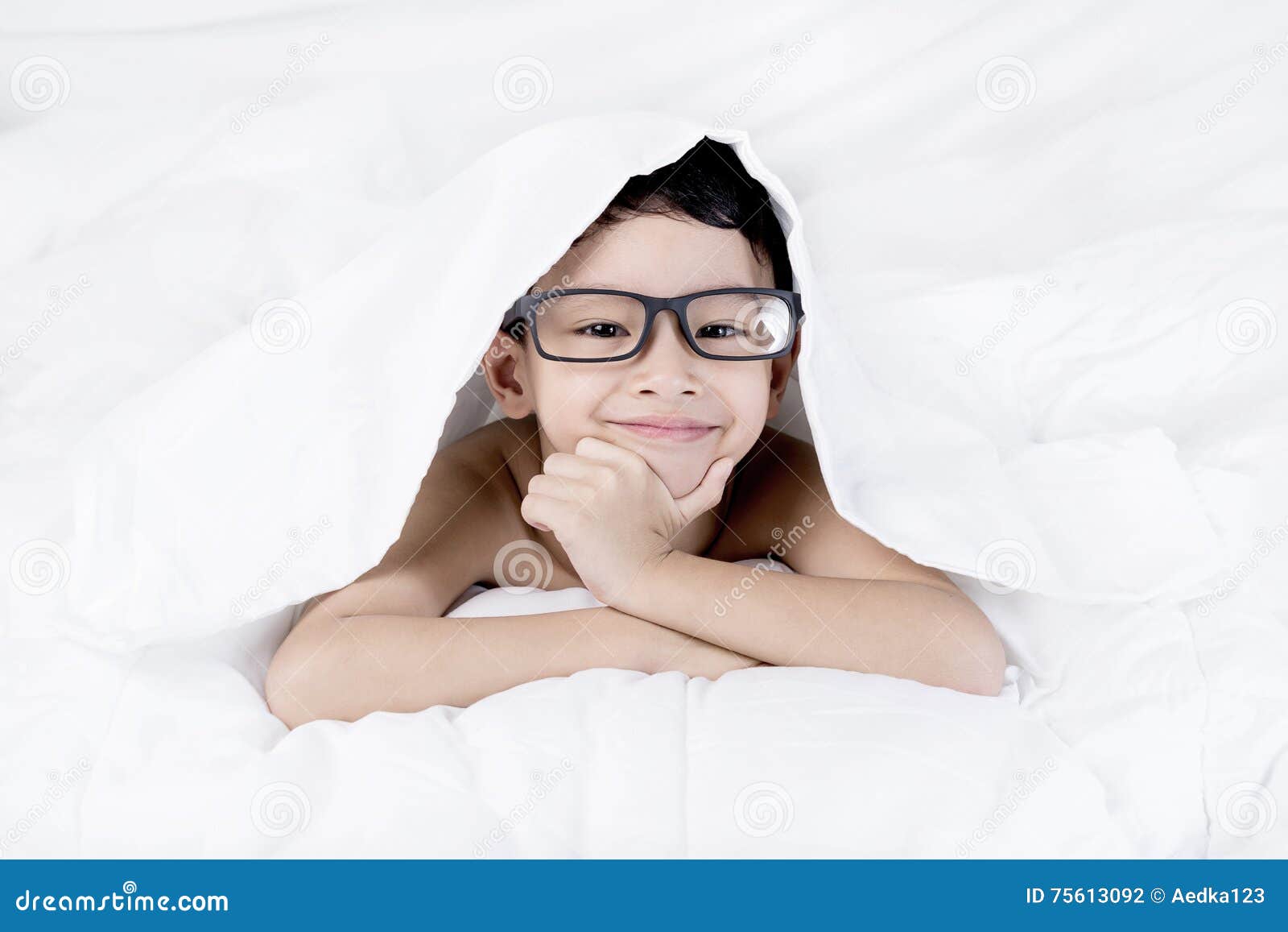 Cute boy lie on bed. stock photo. Image of care, male - 75613092