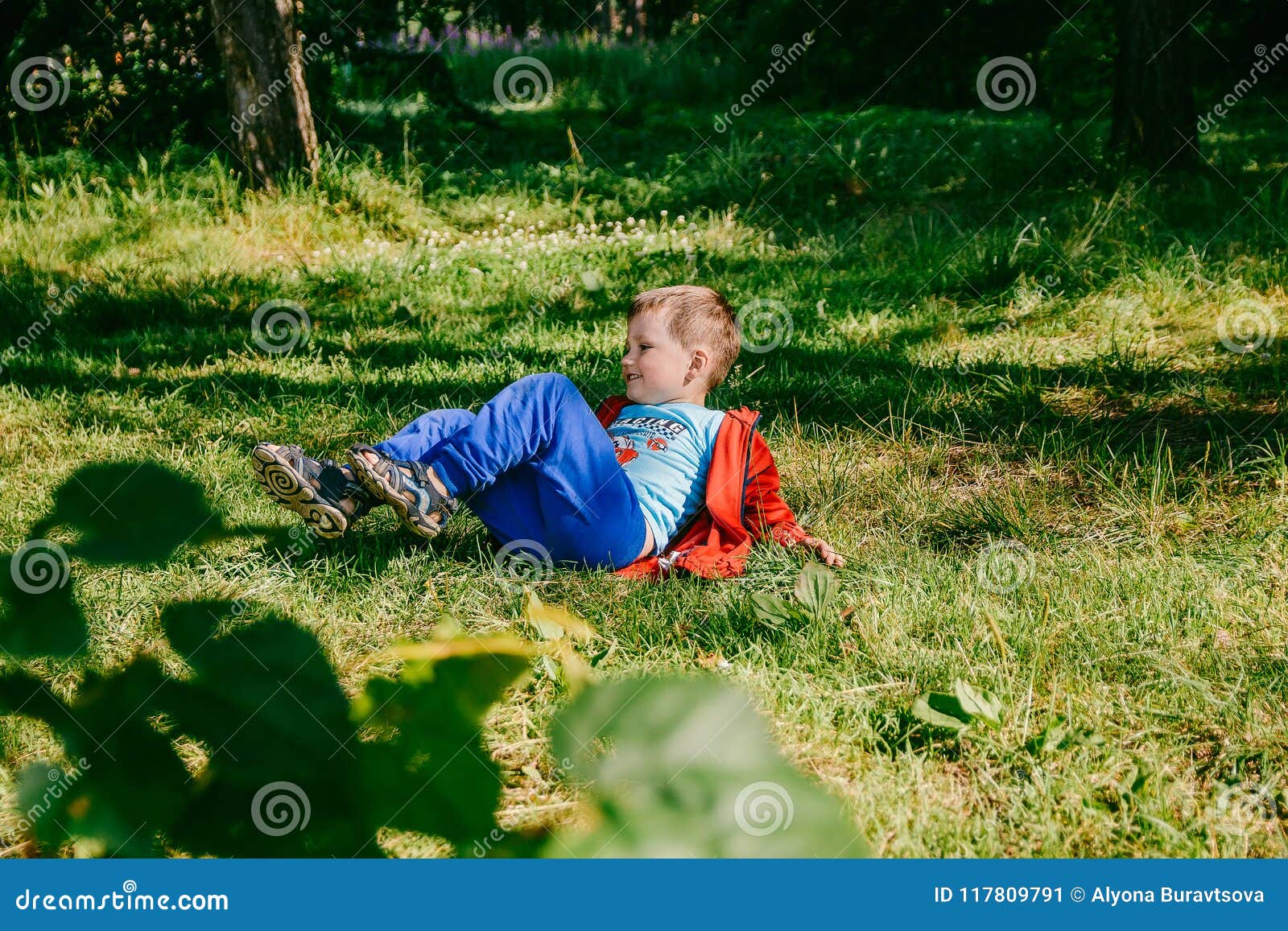 Cute a Boy Lies on Green the Grass Stock Image - Image of holiday, park ...
