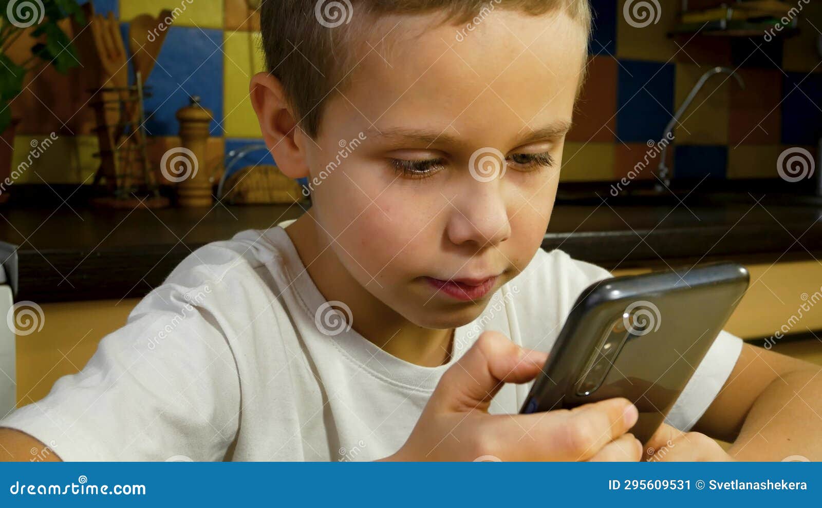 Cute Boy Looking at Smartphone Screen and Talking. Communication with ...