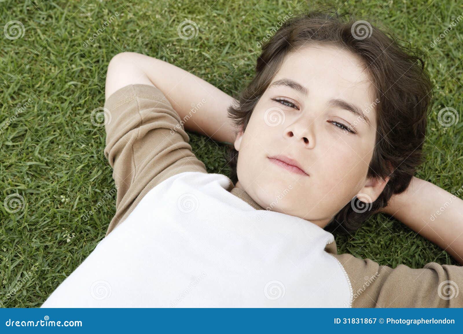 Cute Boy Lying on Grass stock image. Image of head, front - 31831867