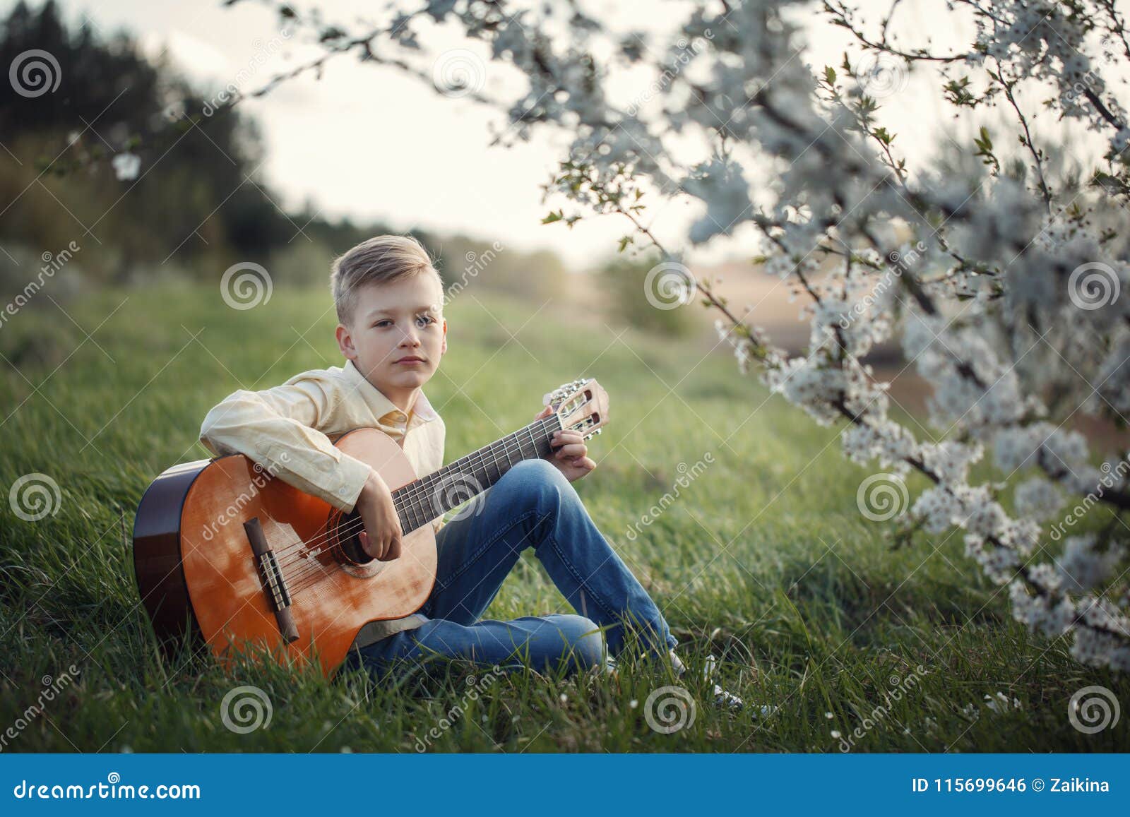 Cute Boy Making Music Playing the Guitar on Nature. Stock Photo - Image ...