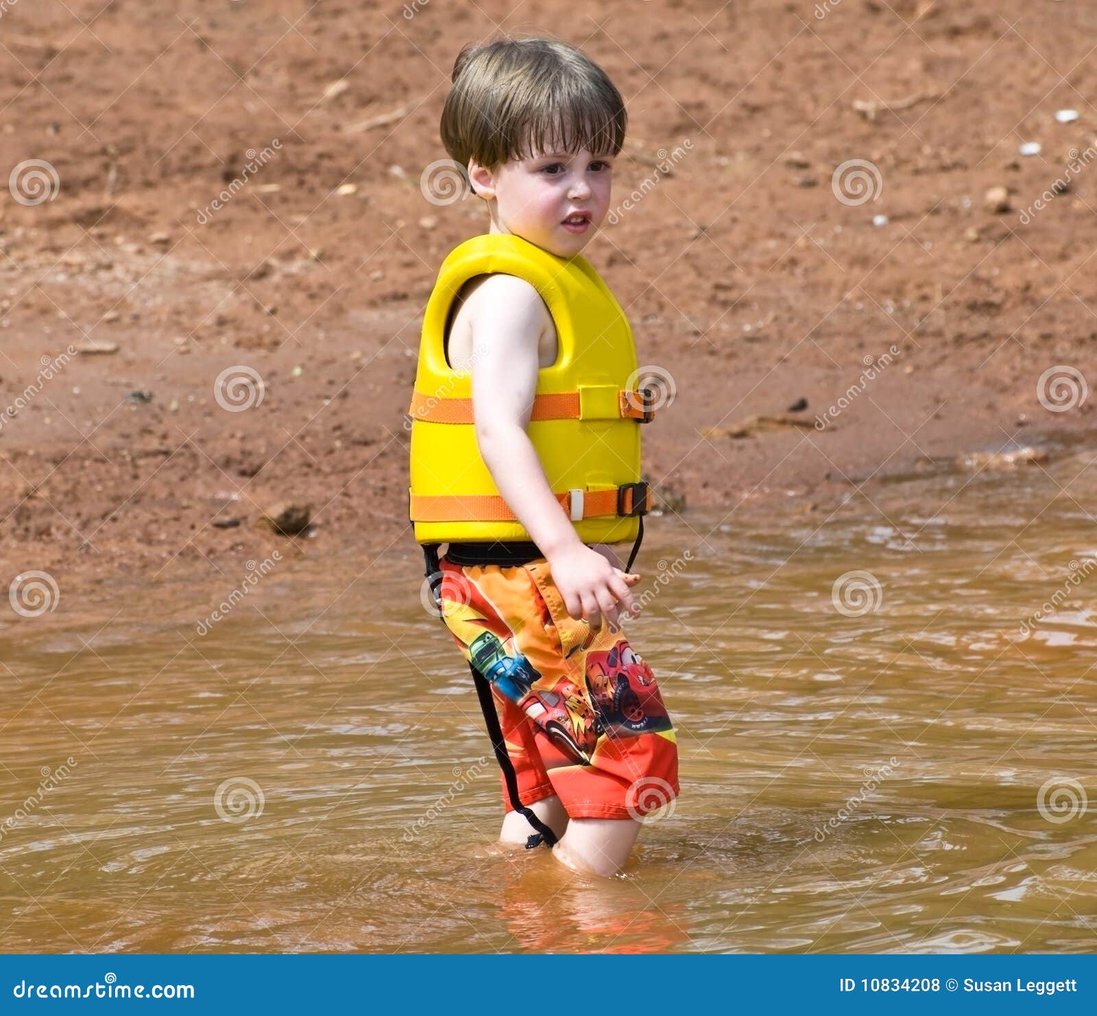 Cute Boy in the Mud stock photo. Image of swimsuit, jacket - 10834208