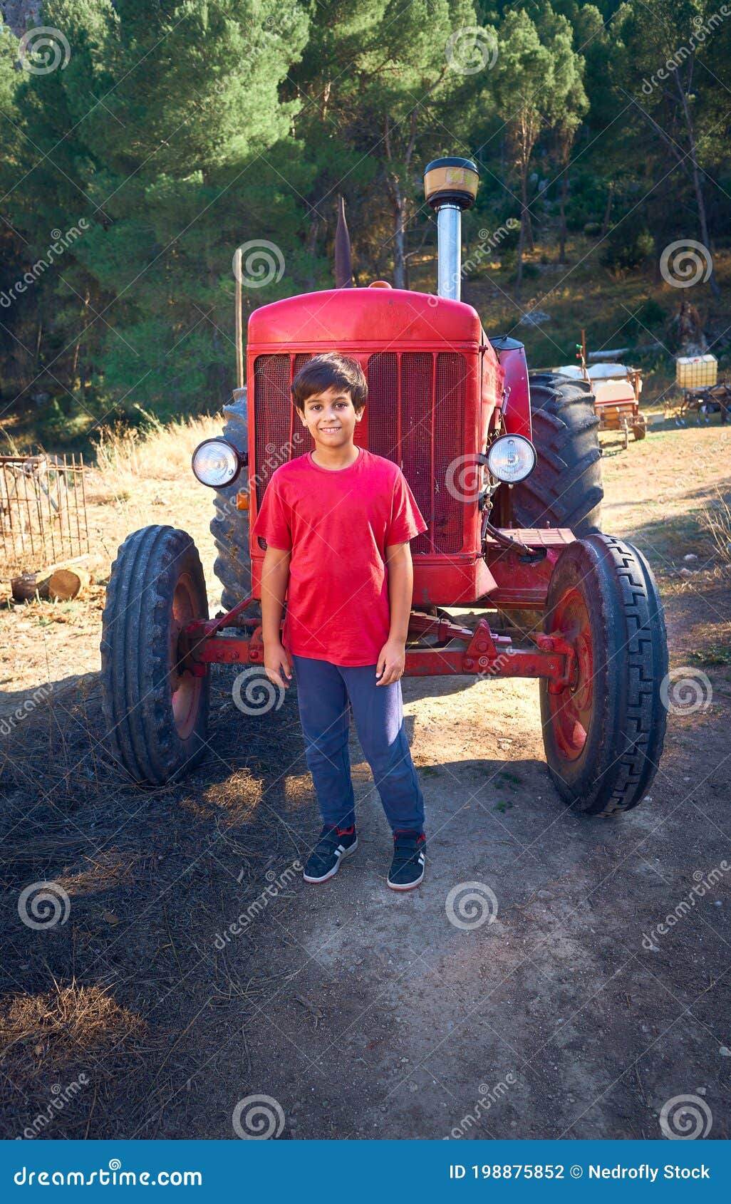 Cute Boy Near the Old Red Tractor in the Field Stock Photo - Image of ...