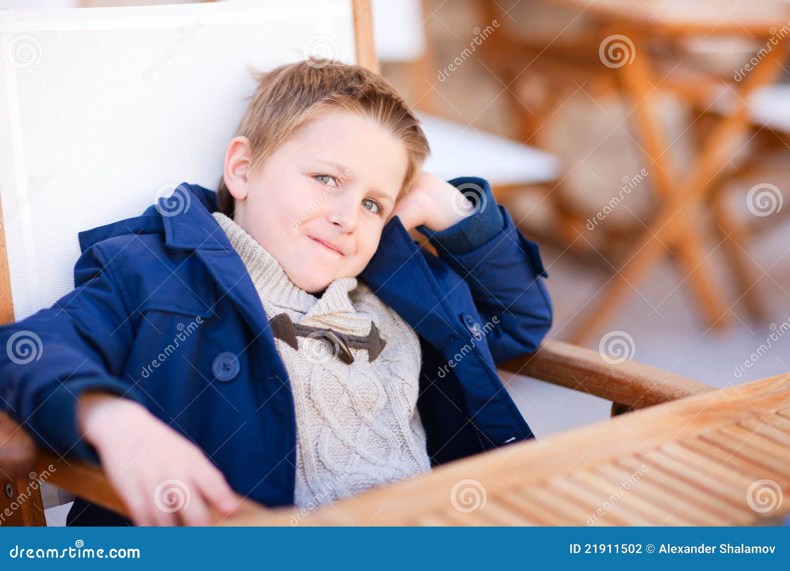 Cute boy at outdoor cafe stock photo. Image of table - 21911502