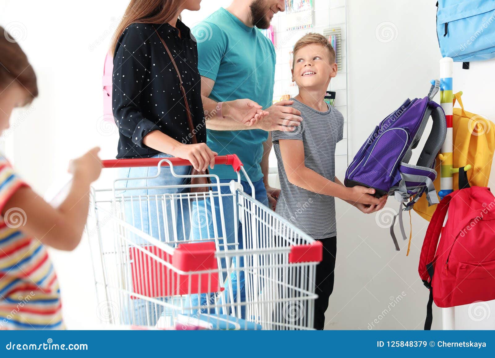 Cute Boy with Parents Choosing Backpack Stock Image - Image of ...