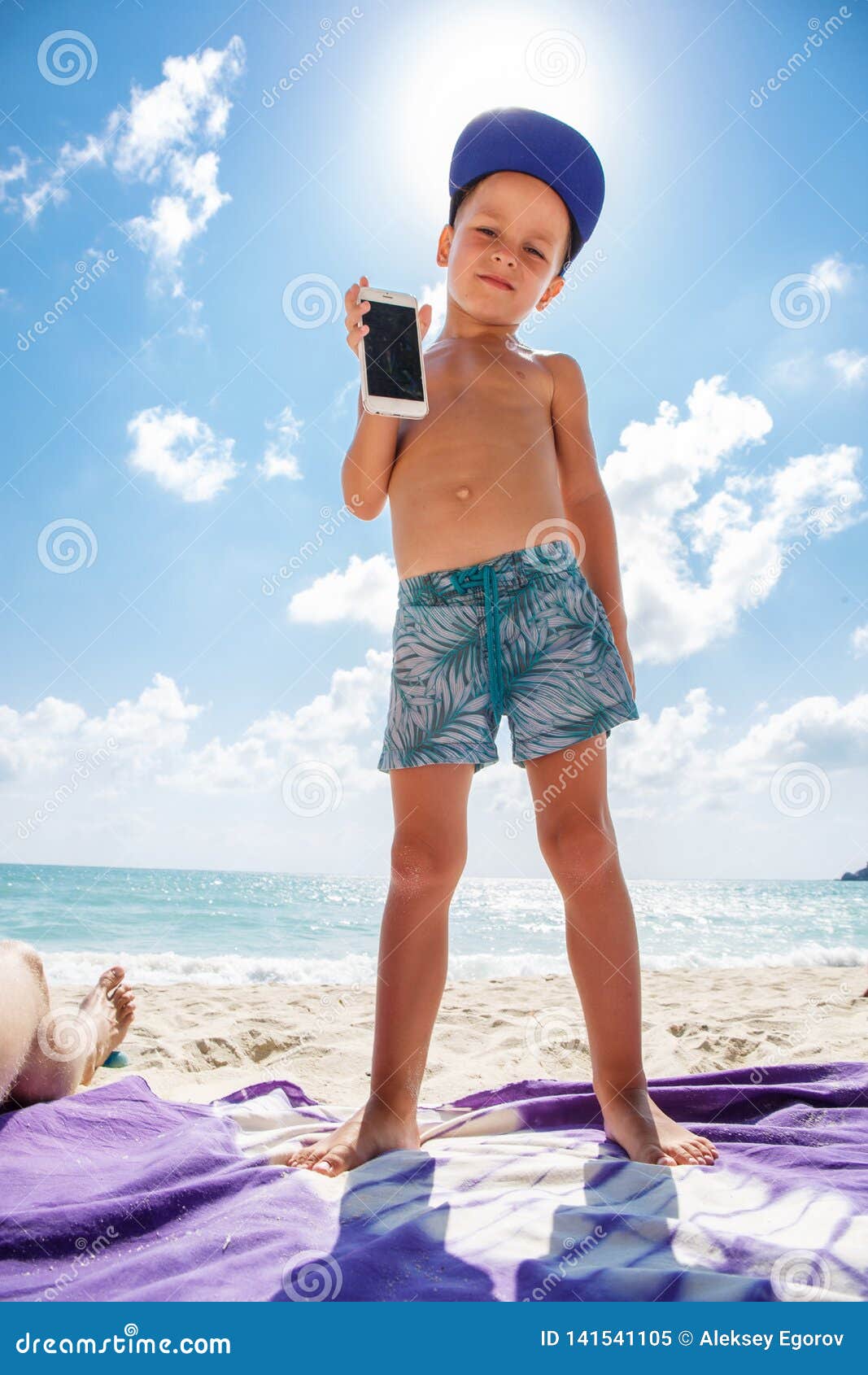 Cute Boy is Playing in a Mobile Phone on the Beach Stock Image - Image ...