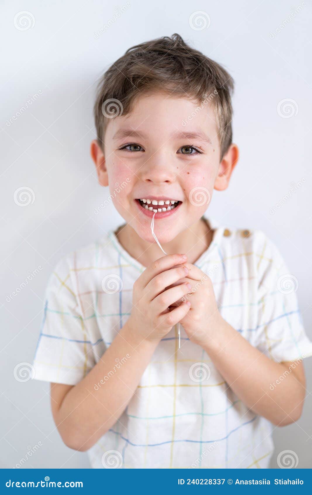 Cute Boy Pulling Loose Tooth Using a Dental Floss. Process of Removing ...