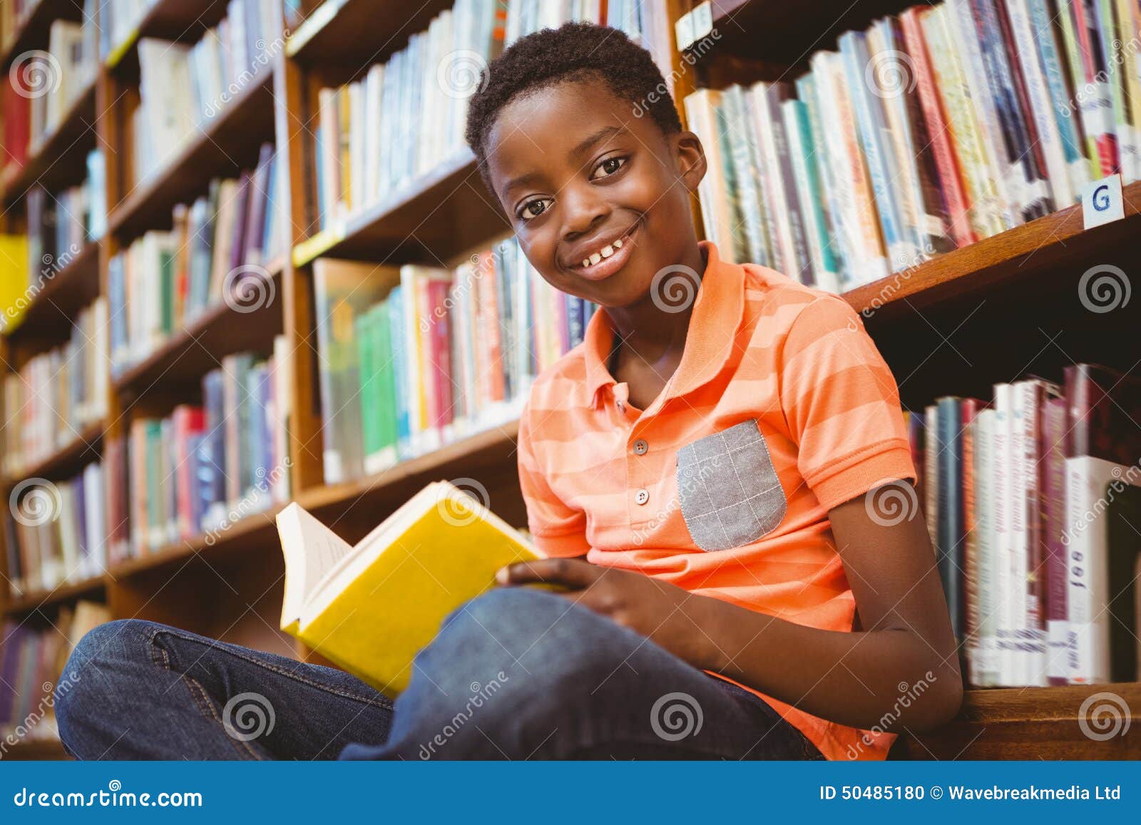 Cute Boy Reading Book in Library Stock Photo - Image of information ...