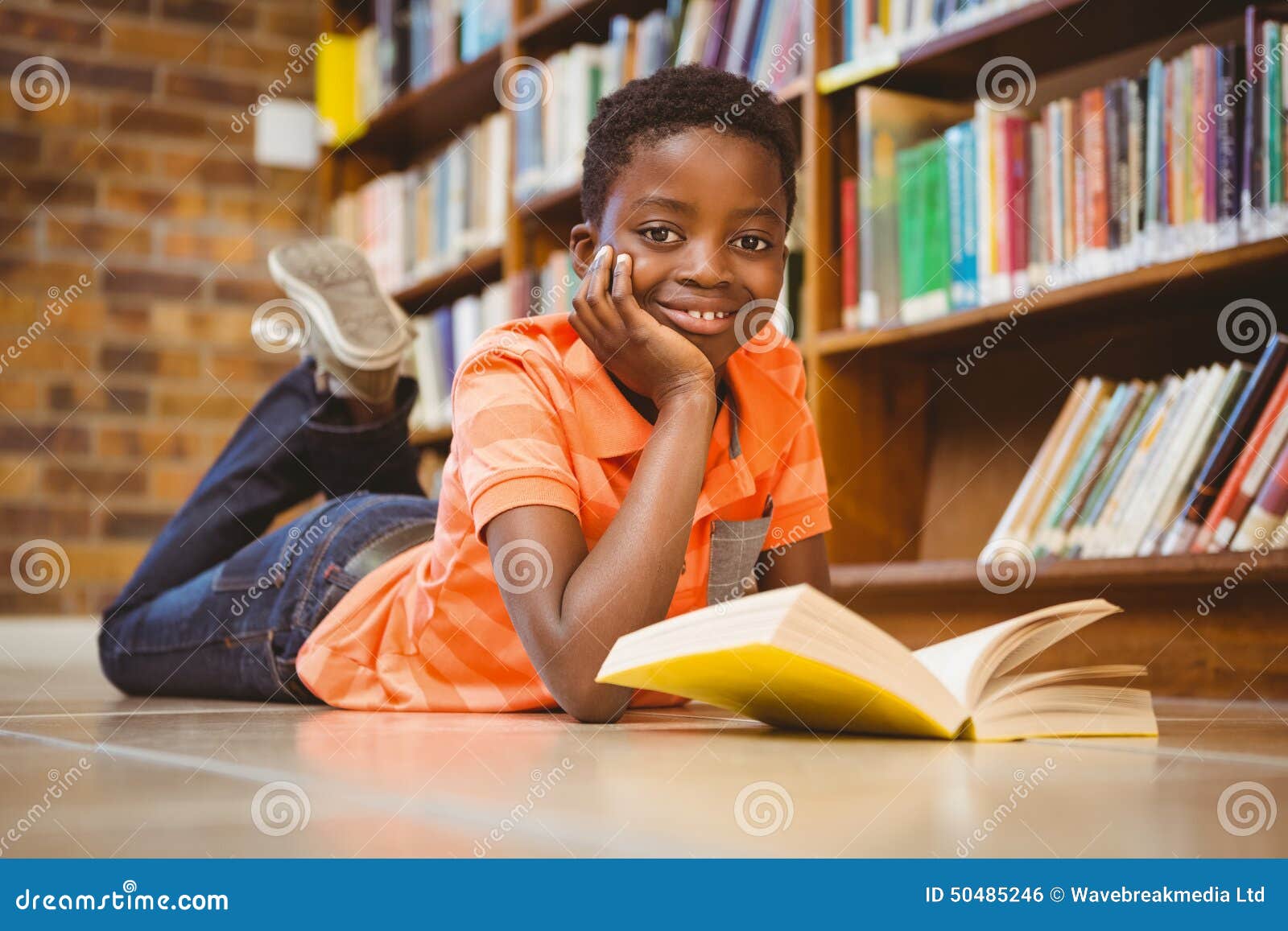 Cute Boy Reading Book in Library Stock Photo - Image of development ...