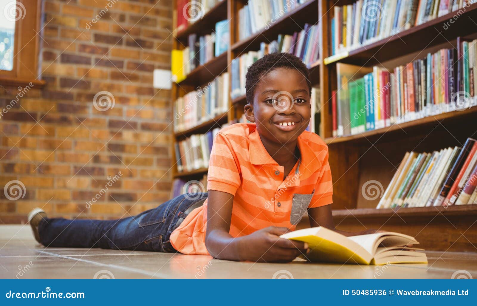 Cute Boy Reading Book in Library Stock Photo - Image of information ...