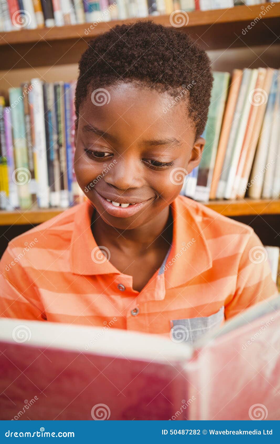 Cute Boy Reading Book in Library Stock Photo - Image of head, childhood ...