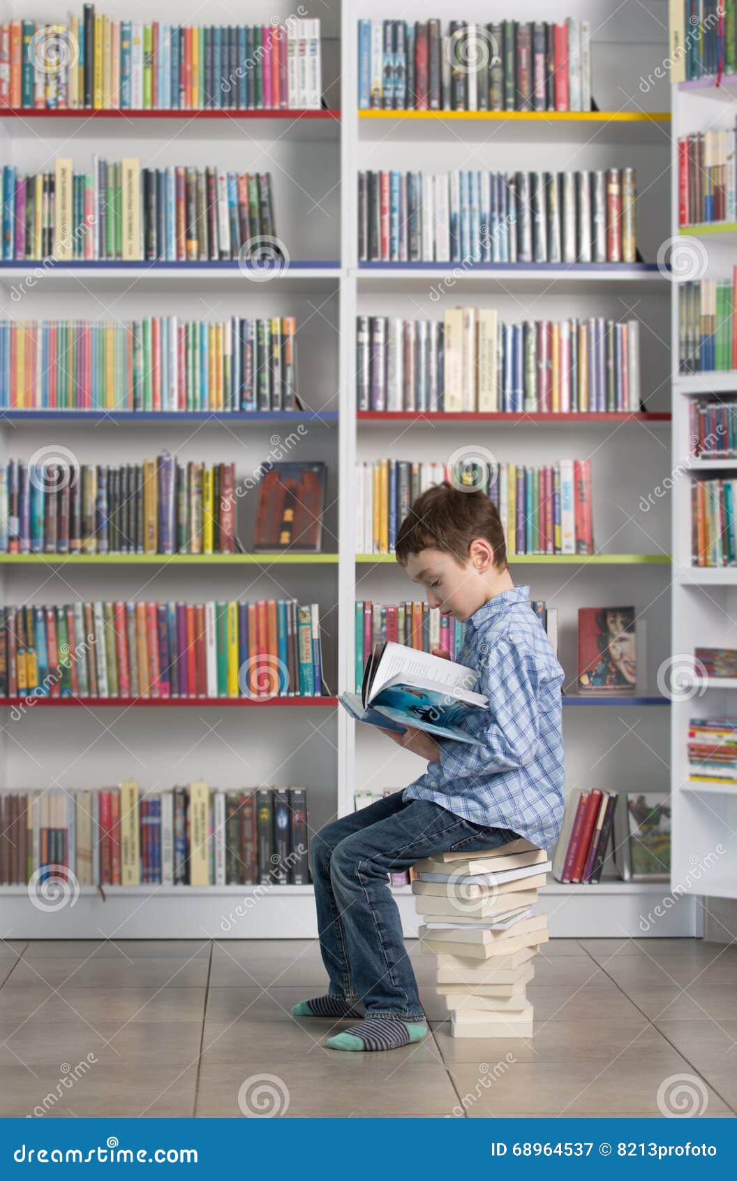 Cute Boy Reading Book in Library Stock Image - Image of childhood ...
