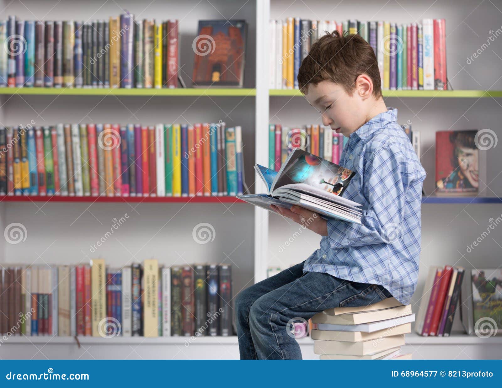 Cute Boy Reading Book in Library Stock Image - Image of computer ...