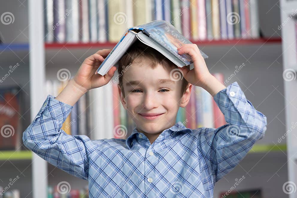 Cute Boy Reading Book in Library Stock Image - Image of child, learning ...