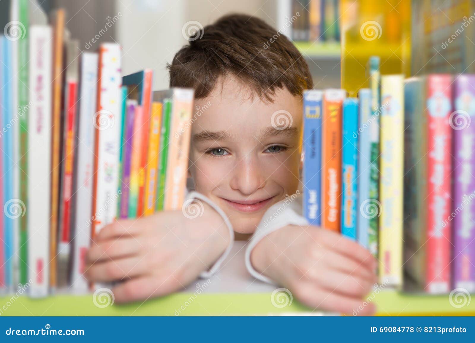 Cute Boy Reading Book in Library Stock Photo - Image of college, desk ...