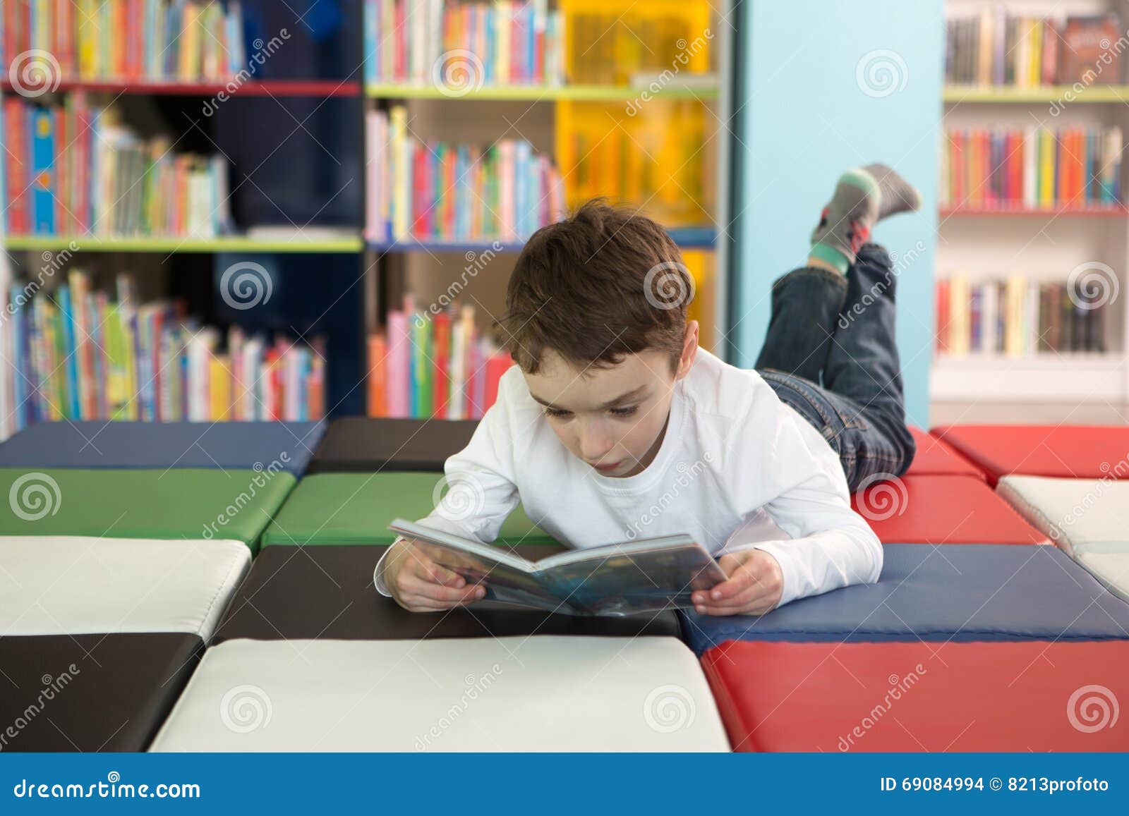 Cute Boy Reading Book in Library Stock Photo - Image of happy, computer ...
