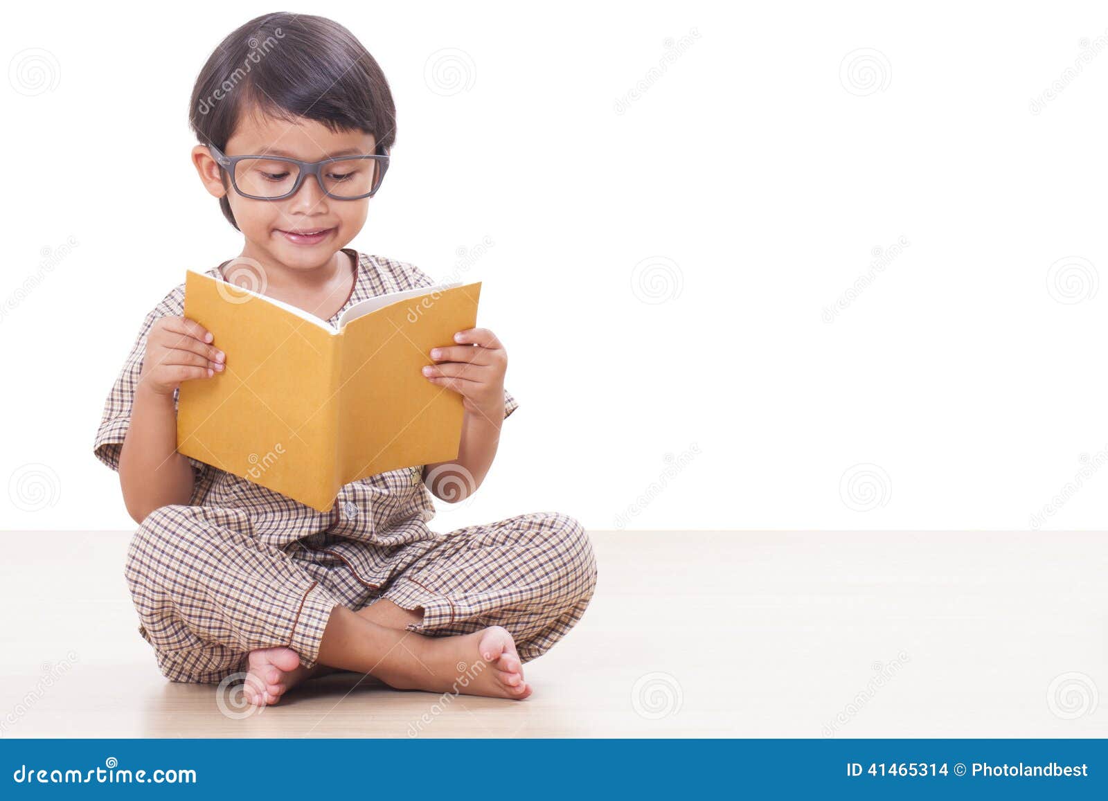 Cute boy is reading a book stock photo. Image of color - 41465314